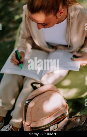 High school girl is underlining important parts from the lecture Stock ...