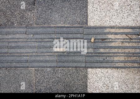 Textured walkway for blind people. Black tactile paving for the ...