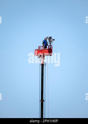 Journalist with microphone on light blue background with space for text ...