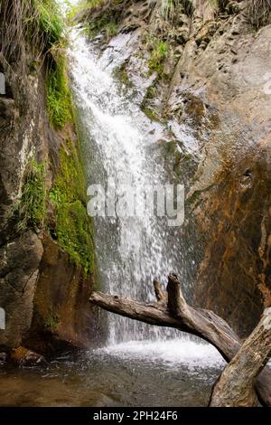 A majestic waterfall cascades through a picturesque valley surrounded ...