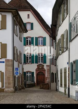 BASEL, SWITZERLAND - FEBRUARY 27, 2023: Ornate signs and flags in the ...