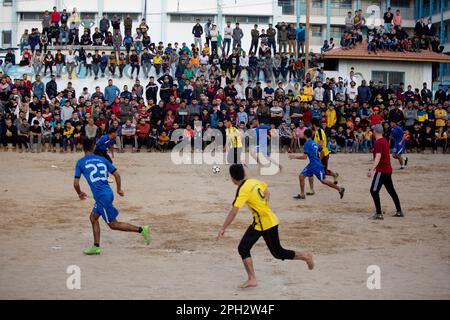 Palestinian youths play football during the holy month of Ramadan in ...