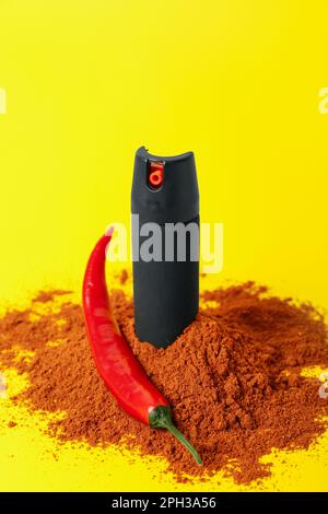 Spray with chili pepper and powder on yellow background Stock Photo - Alamy