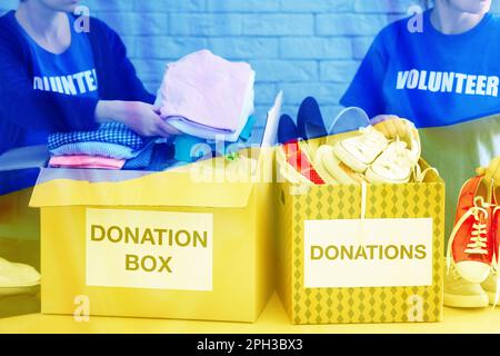 Double exposure of volunteers packing donation boxes and Ukrainian flag ...