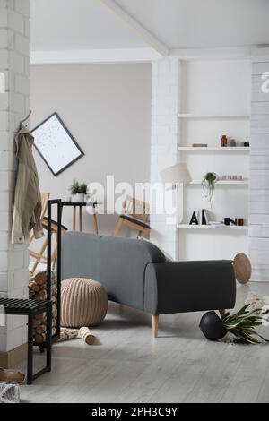 Interior of messy living room with overturned furniture after ...