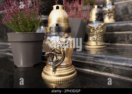 Golden grave lanterns on granite stairs at cemetery Stock Photo - Alamy