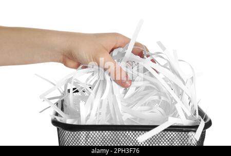Woman taking shredded paper strips into trash bin on white background ...