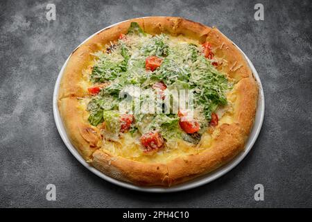 Traditional Caesar pizza displayed on a rustic wood board Stock Photo ...