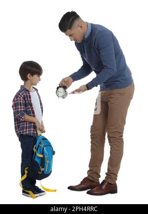 Teacher with alarm clock scolding pupil for being late in classroom ...