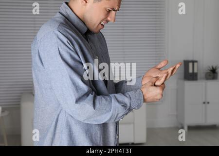 Man suffering from trigger finger at home, closeup Stock Photo - Alamy