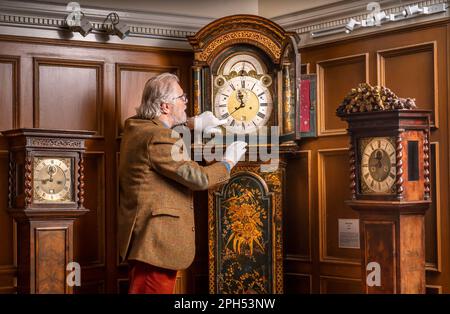 President of the British Horological Institute Alan Midleton, adjusts ...
