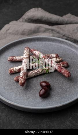 Spanish mini fuet on the grey plate Stock Photo - Alamy
