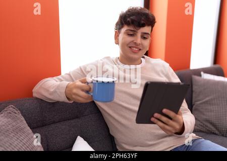 Non binary person using touchpad device at night surprised pointing ...