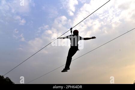 Guwahati, Guwahati, India. 24th Mar, 2023. A youth travel in Zip line ...