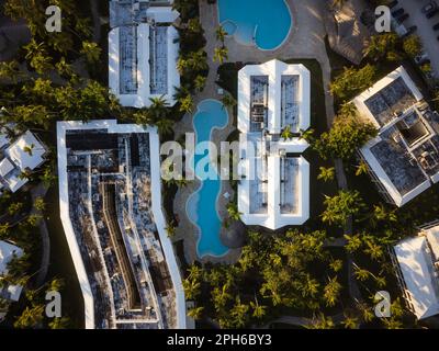 Shooting from a drone. Resort. Hotel rooftops, swimming pool, car ...