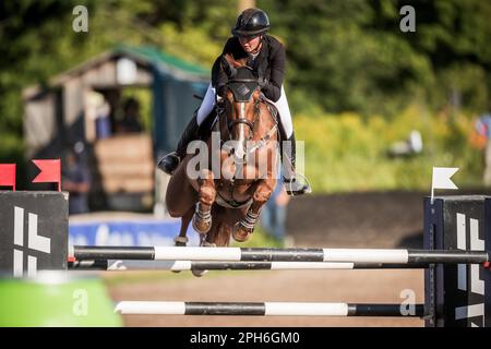 A professional rider competes on the Major League Show Jumping Tour in ...