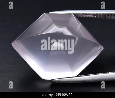 Large pink crystal on a pale blue knitted table Stock Photo - Alamy