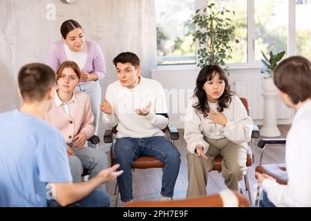 Teenagers communicate with the teacher in a free form during lesson at ...