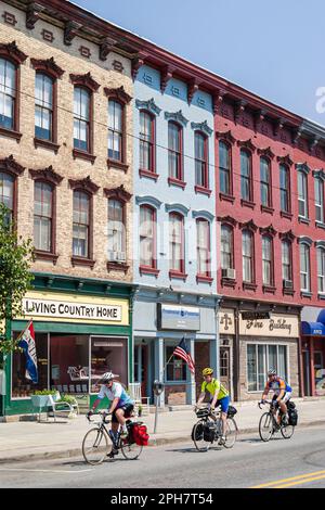 Cyclists riding in front of cityscape Stock Photo - Alamy