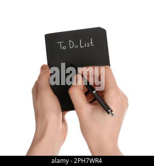 Woman filling To Do list in notepad at light grey marble table, top ...