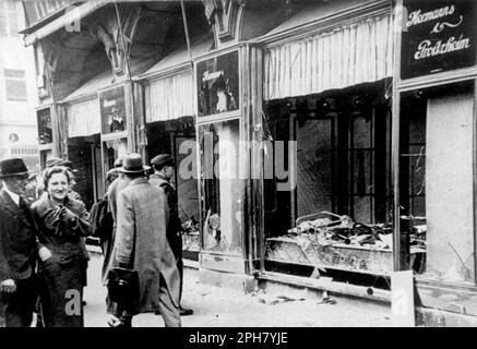 People walking past smashed Jewish shops in Magdeburg. Kristallnacht ...