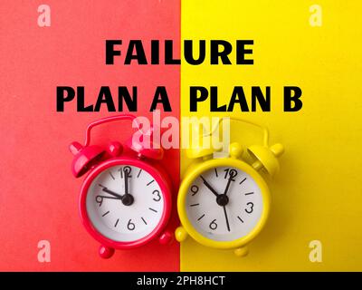 A colored alarm clock with the word FAILURE PLAN A and B - Business ...