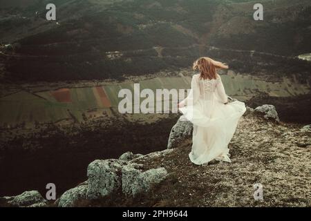 Lone woman on a desolate mountain Stock Photo - Alamy