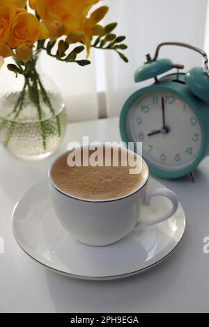 Alarm clock, coffee and flowers. Morning mood, on white background, top ...