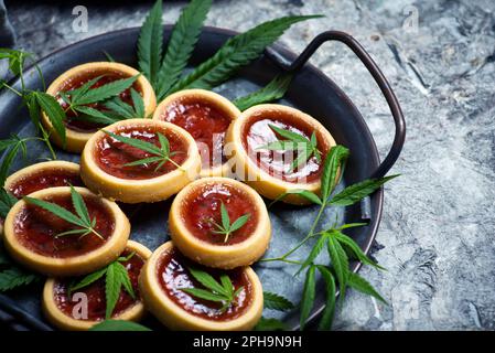 Marijuana butter on wooden table coffee gingerbread and green color ...