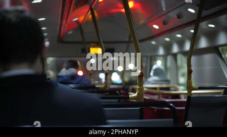 Back of bus interior at night in movement. Inside British public ...