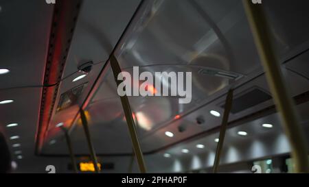 Back of bus interior at night in movement. Inside British public ...
