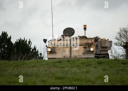 British army FV432 Bulldog APC hurtles down a country lane on a ...