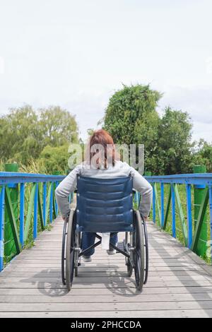 Close up of an unknown person using a hand saw to cut up a plank of ...