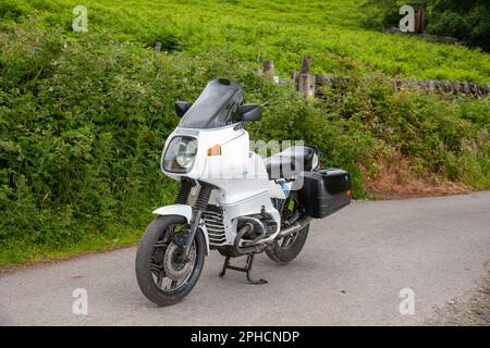 BMW R100 RS touring motocycle parked on a narrow country lane next to ...