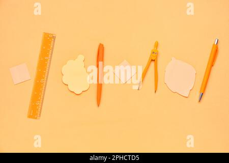 Composition with sticky notes, pens and ruler on yellow background ...
