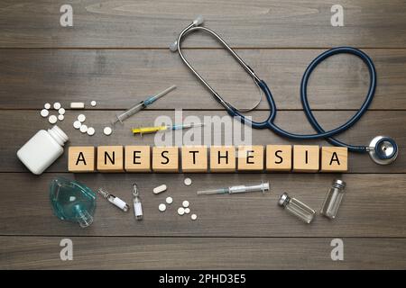 Word Anesthesia made of wooden cubes, stethoscope and drugs on table ...