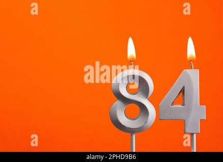 Candle number 84 - Birthday in blues foamy background Stock Photo - Alamy