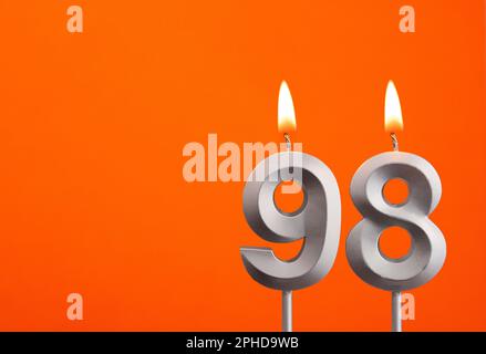 Candle number 98 - Birthday in blues foamy background Stock Photo - Alamy