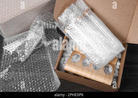 Test tubes in cardboard box and bubble wrap on dark wooden table Stock ...