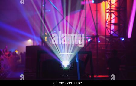 Colorful beams of bright laser light illuminating music venue during ...