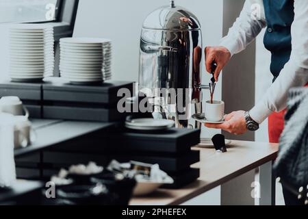 The waiter preparing coffee for hotel guests. Close up photo of service ...