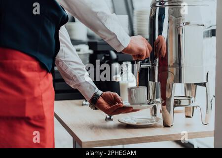 The waiter preparing coffee for hotel guests. Close up photo of service ...