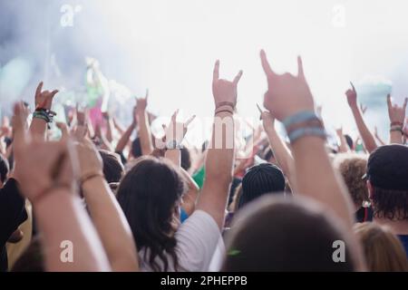 Crop hands of anonymous people having fun on magnificent music show ...
