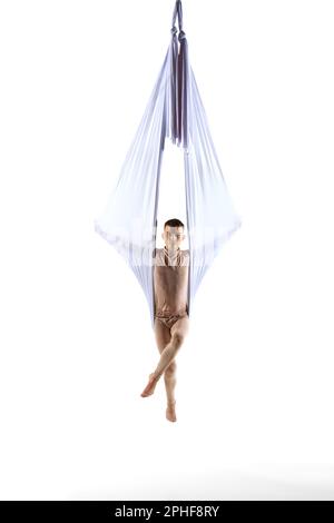 Levitation. Young man, professional aerial acrobat, gymnast training ...