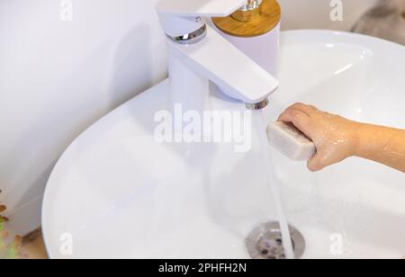The child washes his hands with soap. Selective focus. Kid Stock Photo ...