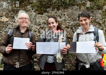 Three pilgrims show their pilgrim credentials. Camino de Santiago ...