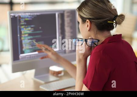 Female programmer checkups code working on computer Stock Photo - Alamy