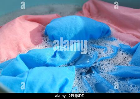 Colorful clothes in suds, closeup. Hand washing laundry Stock Photo - Alamy