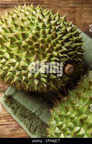Ripe durians on wooden table, top view with space for text. Banner ...