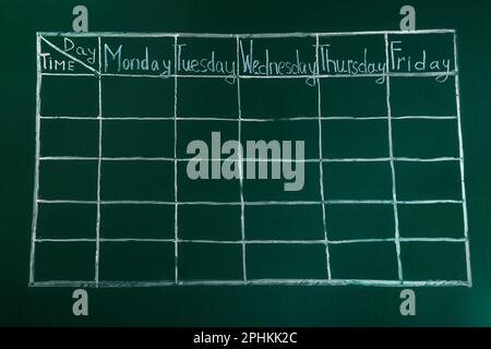 Weekly school timetable drawn on green chalkboard Stock Photo - Alamy